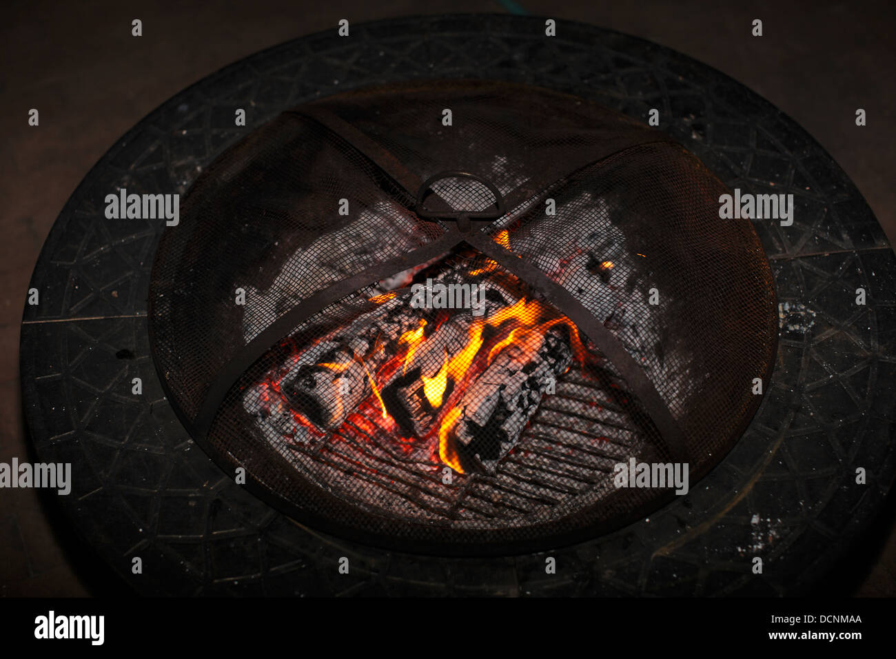 Fire burning in metal fire pit Stock Photo - Alamy