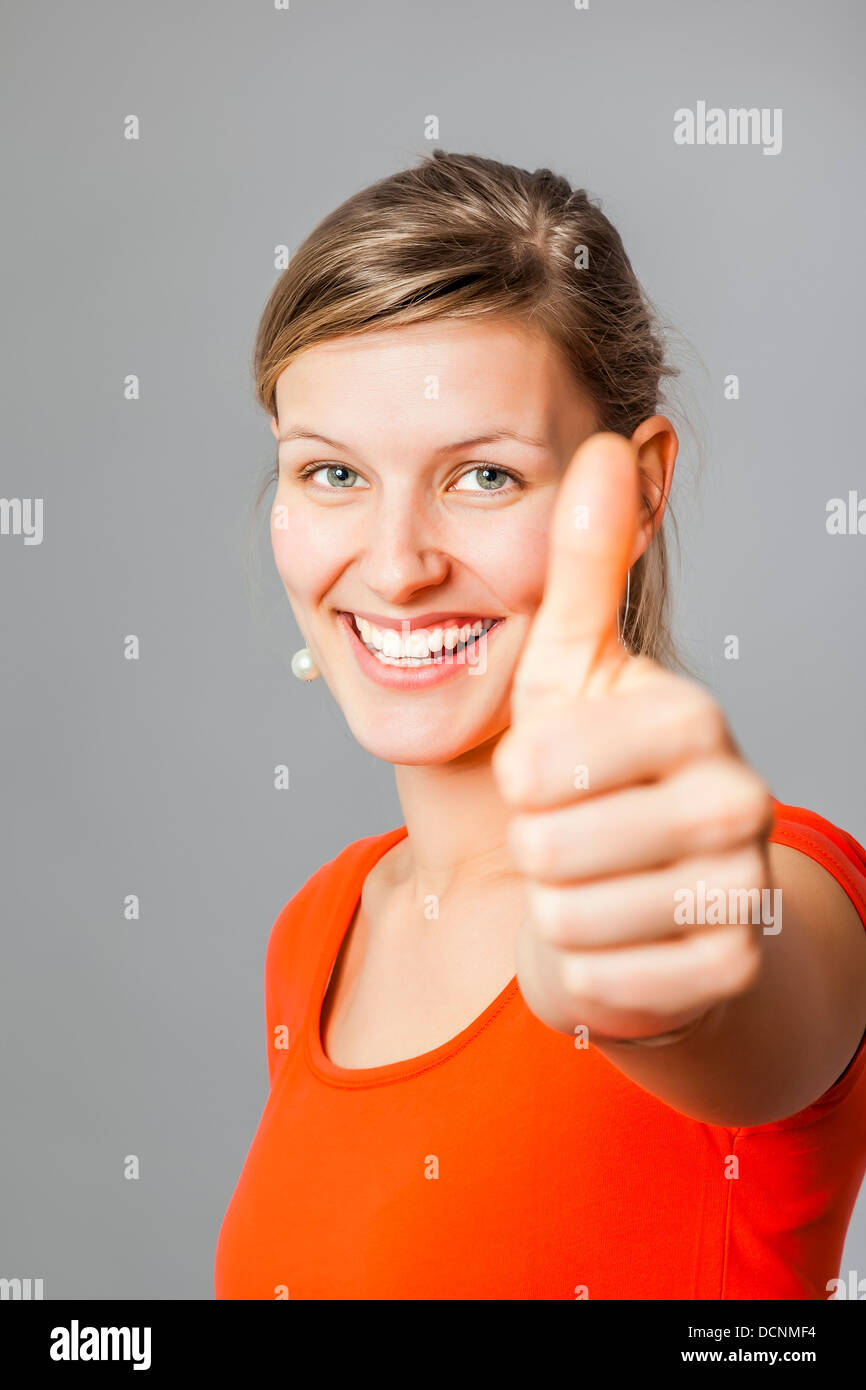 young woman thumb up Stock Photo - Alamy