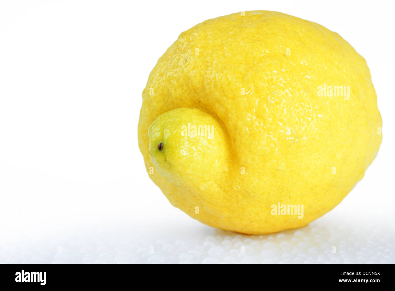 Bright yellow wet lemon over white Stock Photo - Alamy