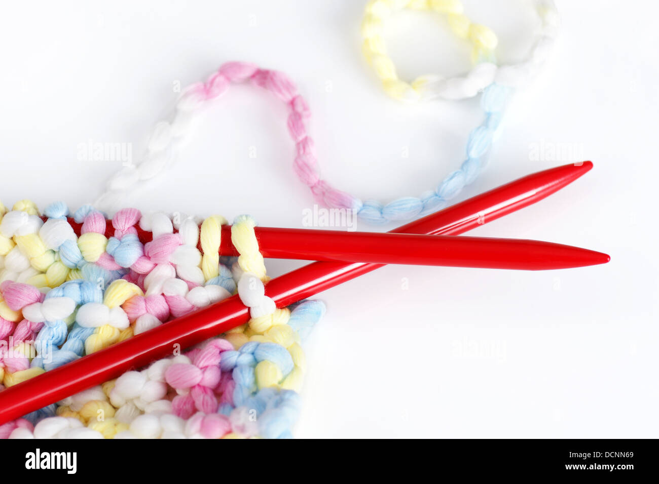 Needles and baby colors knitting Stock Photo - Alamy
