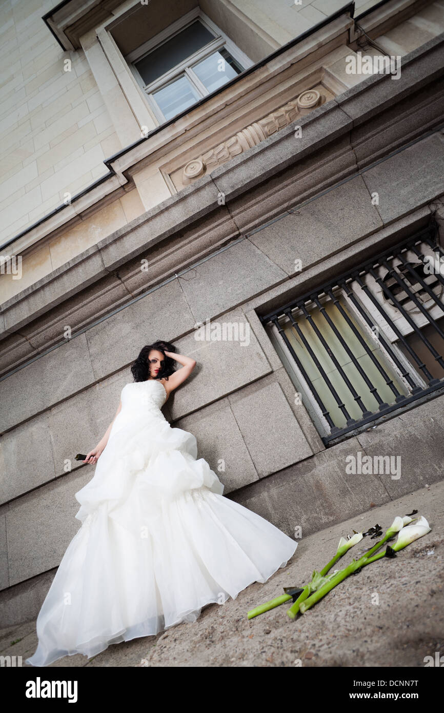 frustrated bride leaning on wall Stock Photo - Alamy