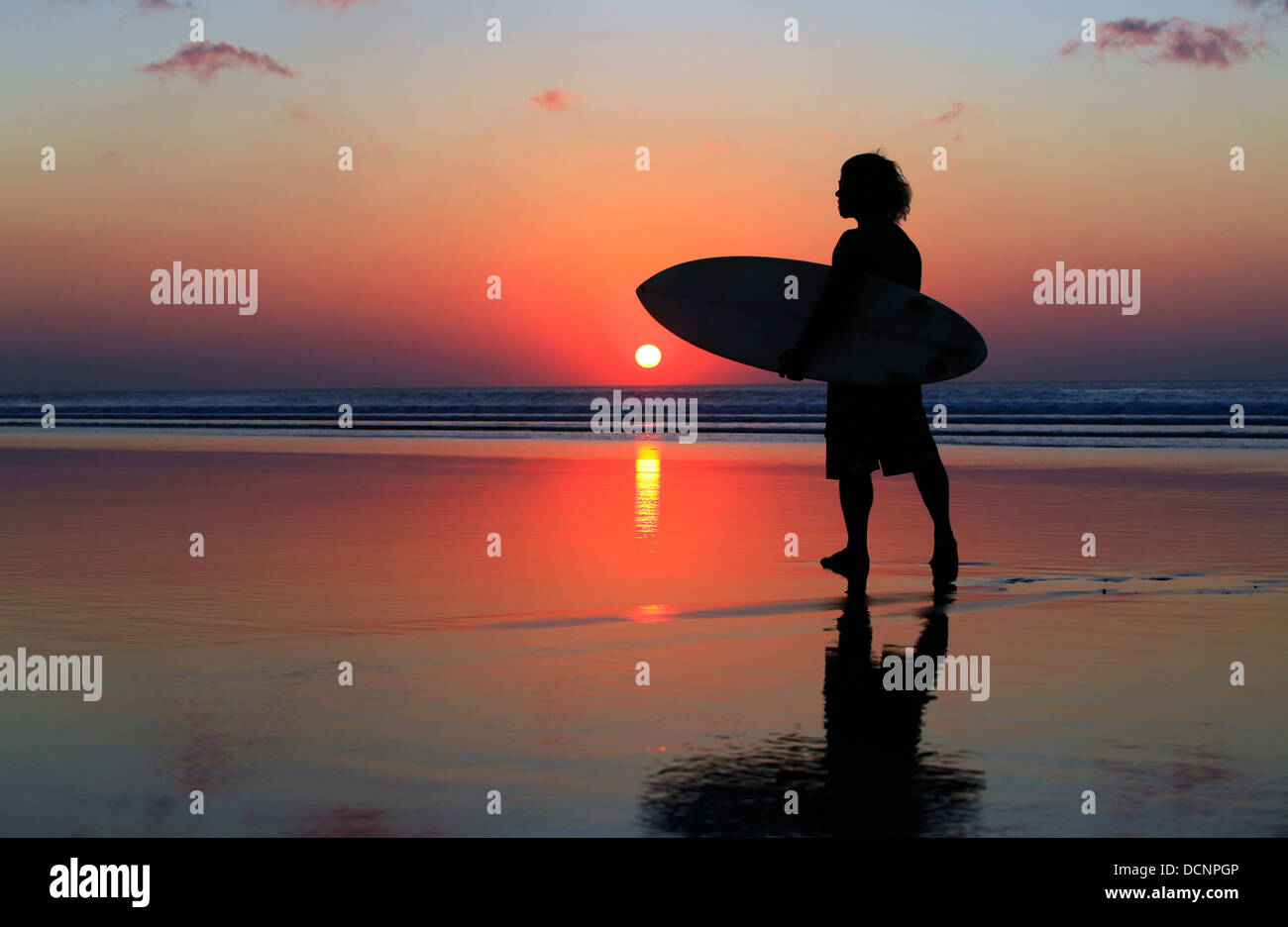 Surfer on sunset Stock Photo - Alamy