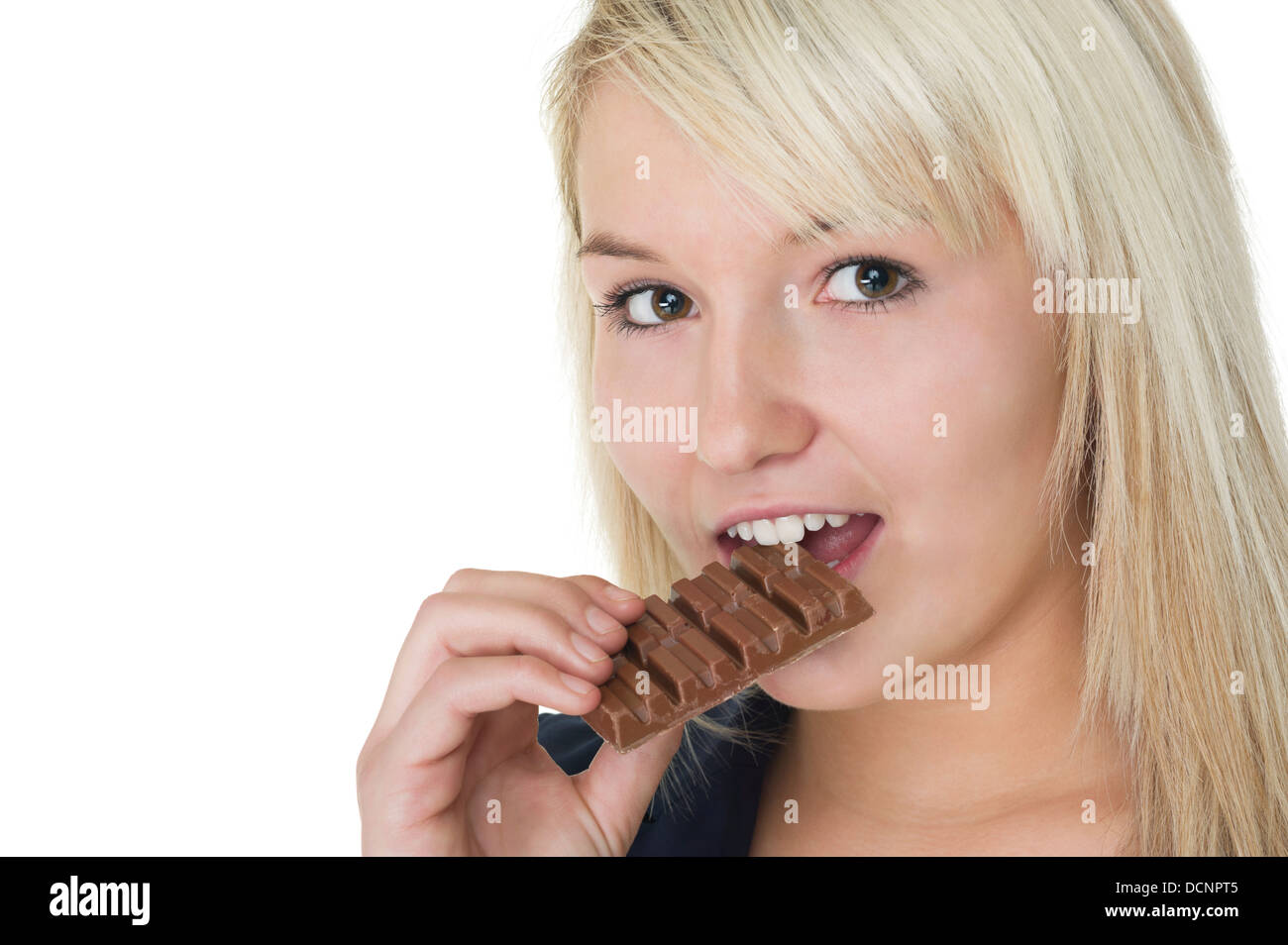 Attractive woman eating chocolate Stock Photo - Alamy