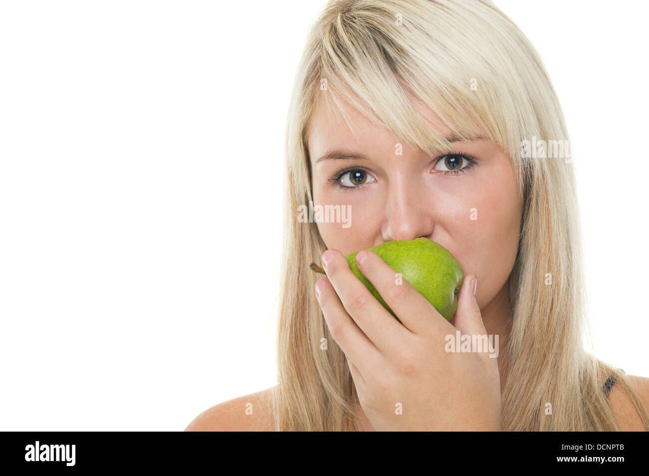 Woman eating a green pear Stock Photo - Alamy