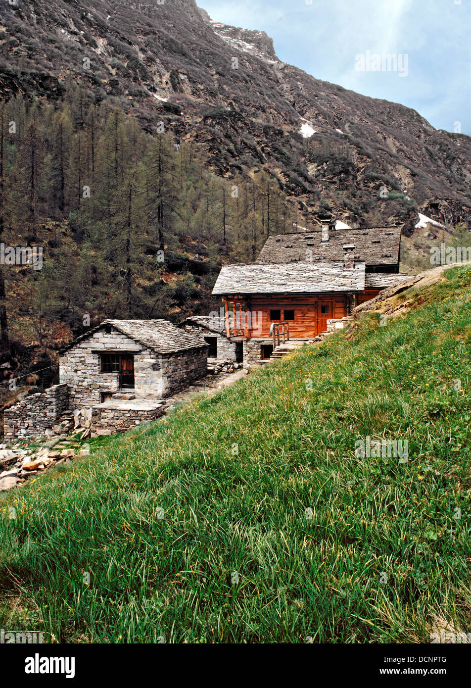 two old farm buildings made of stone in the mountains of Piedmont in ...