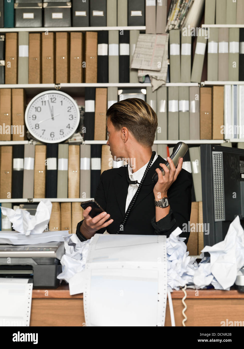 Looking at clock Stock Photo - Alamy