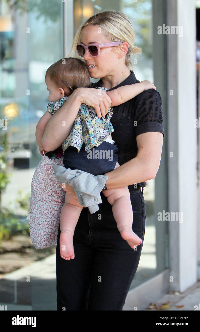 Brady Cunningham carries her daughter Marlowe as she leaves Le Pain ...