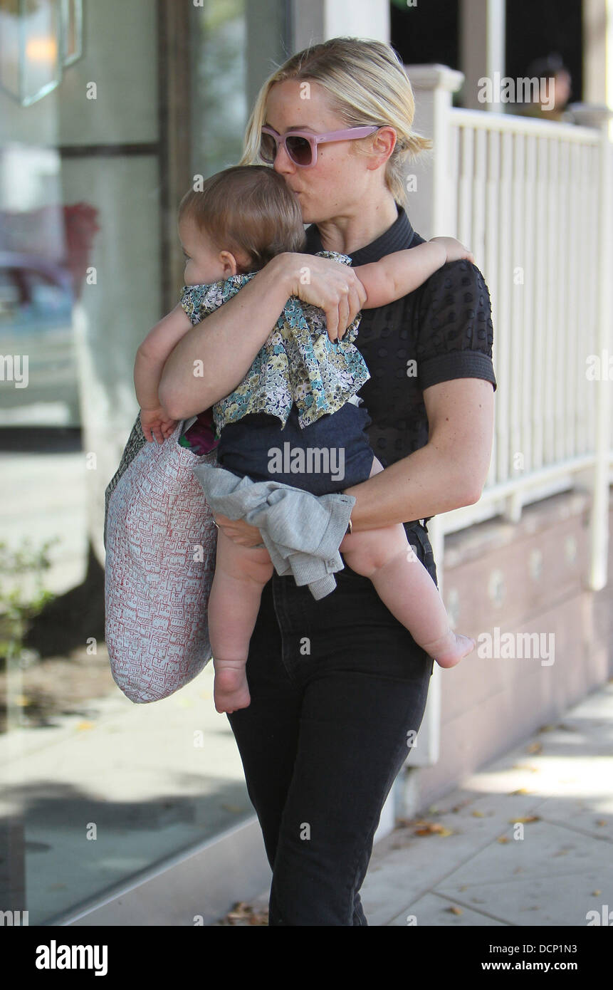 Brady Cunningham carries her daughter Marlowe as she leaves Le Pain ...