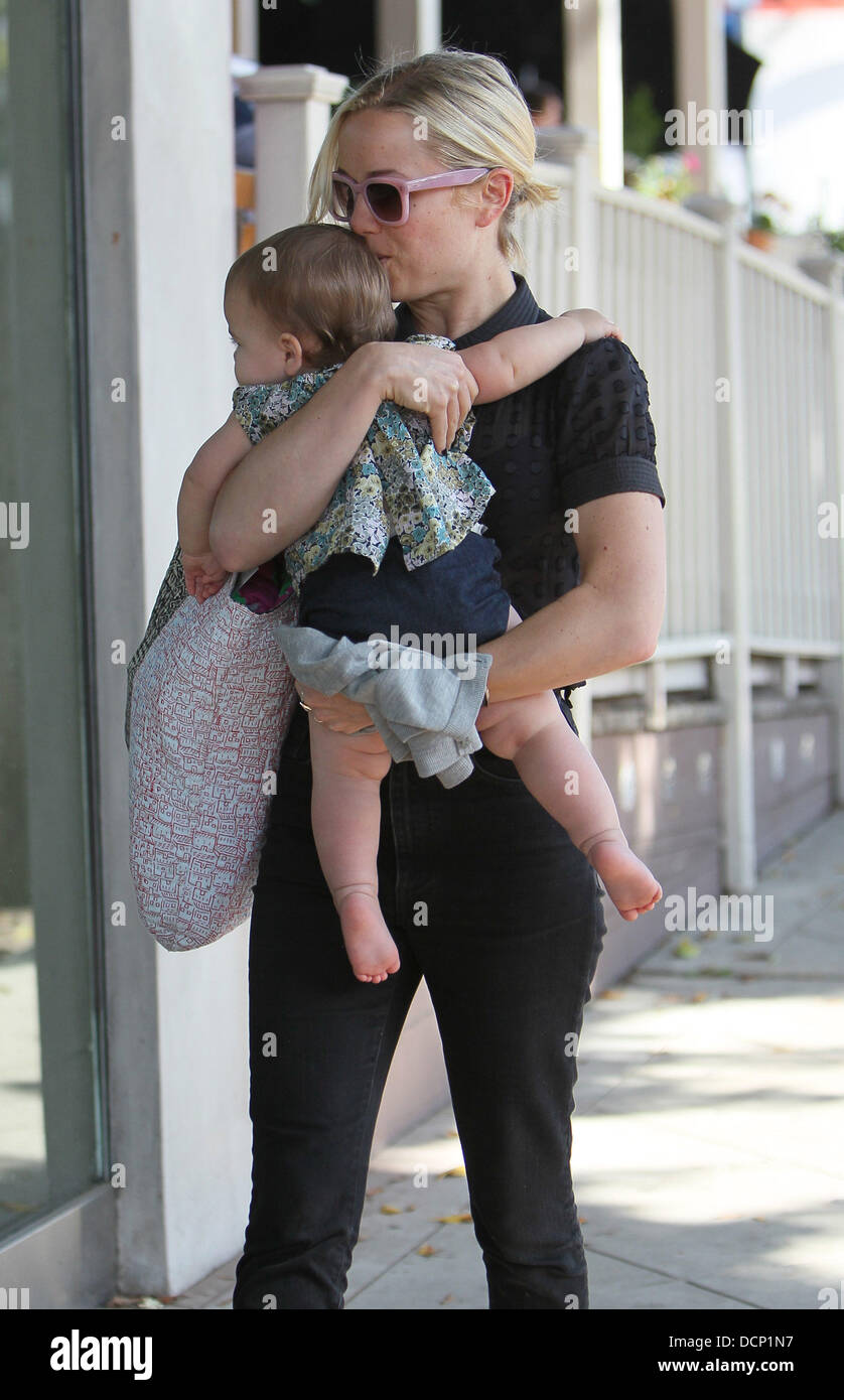 Brady Cunningham carries her daughter Marlowe as she leaves Le Pain ...