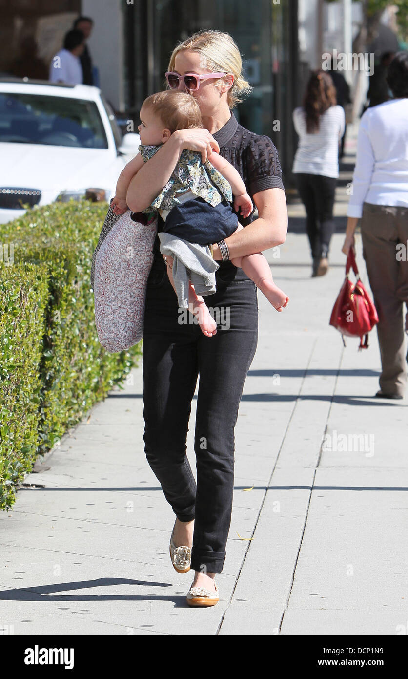 Brady Cunningham carries her daughter Marlowe as she leaves Le Pain ...