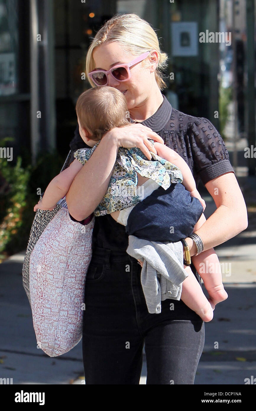 Brady Cunningham carries her daughter Marlowe as she leaves Le Pain ...