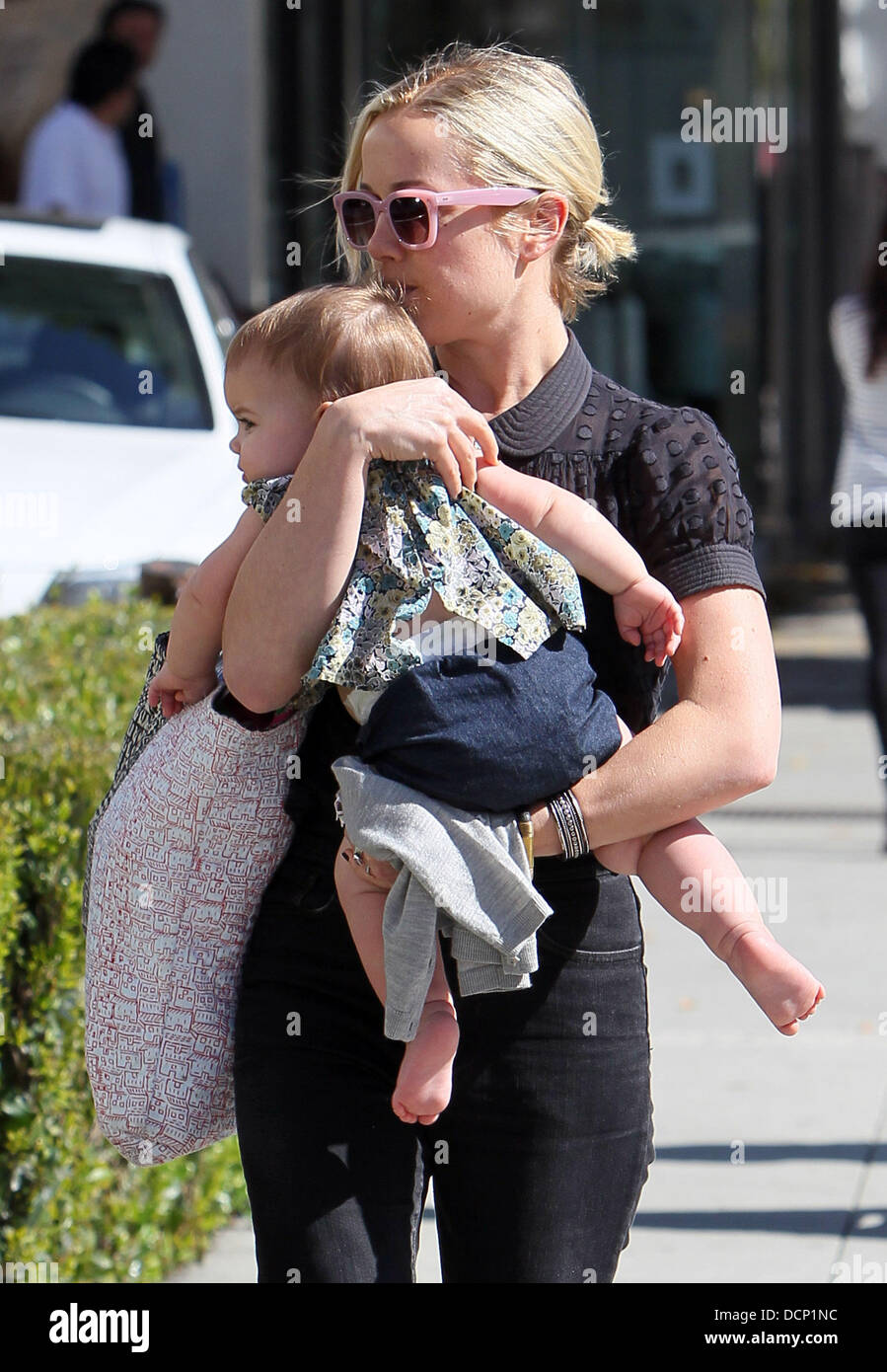 Brady Cunningham carries her daughter Marlowe as she leaves Le Pain ...