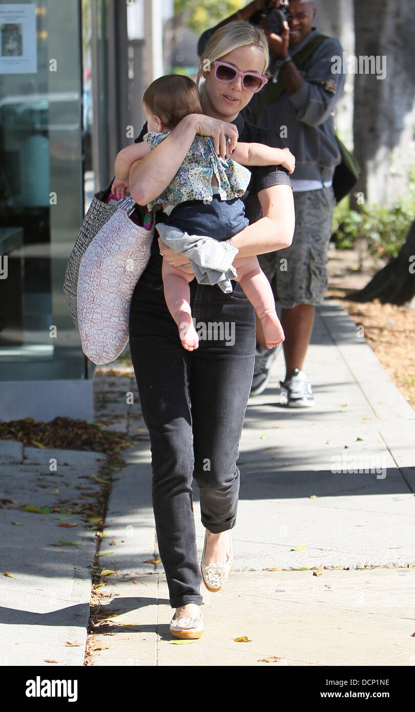 Brady Cunningham carries her daughter Marlowe as she leaves Le Pain ...