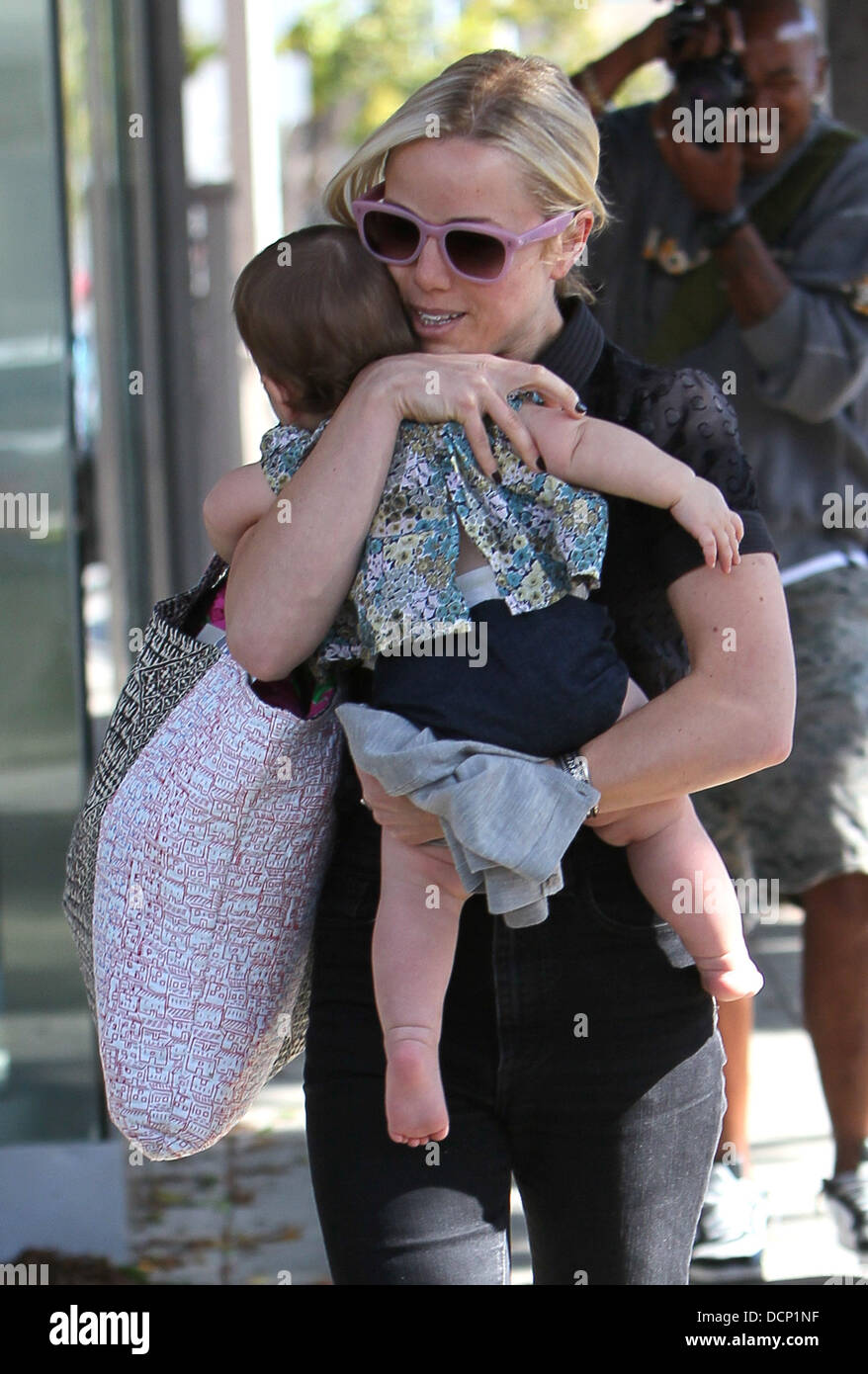 Brady Cunningham carries her daughter Marlowe as she leaves Le Pain ...