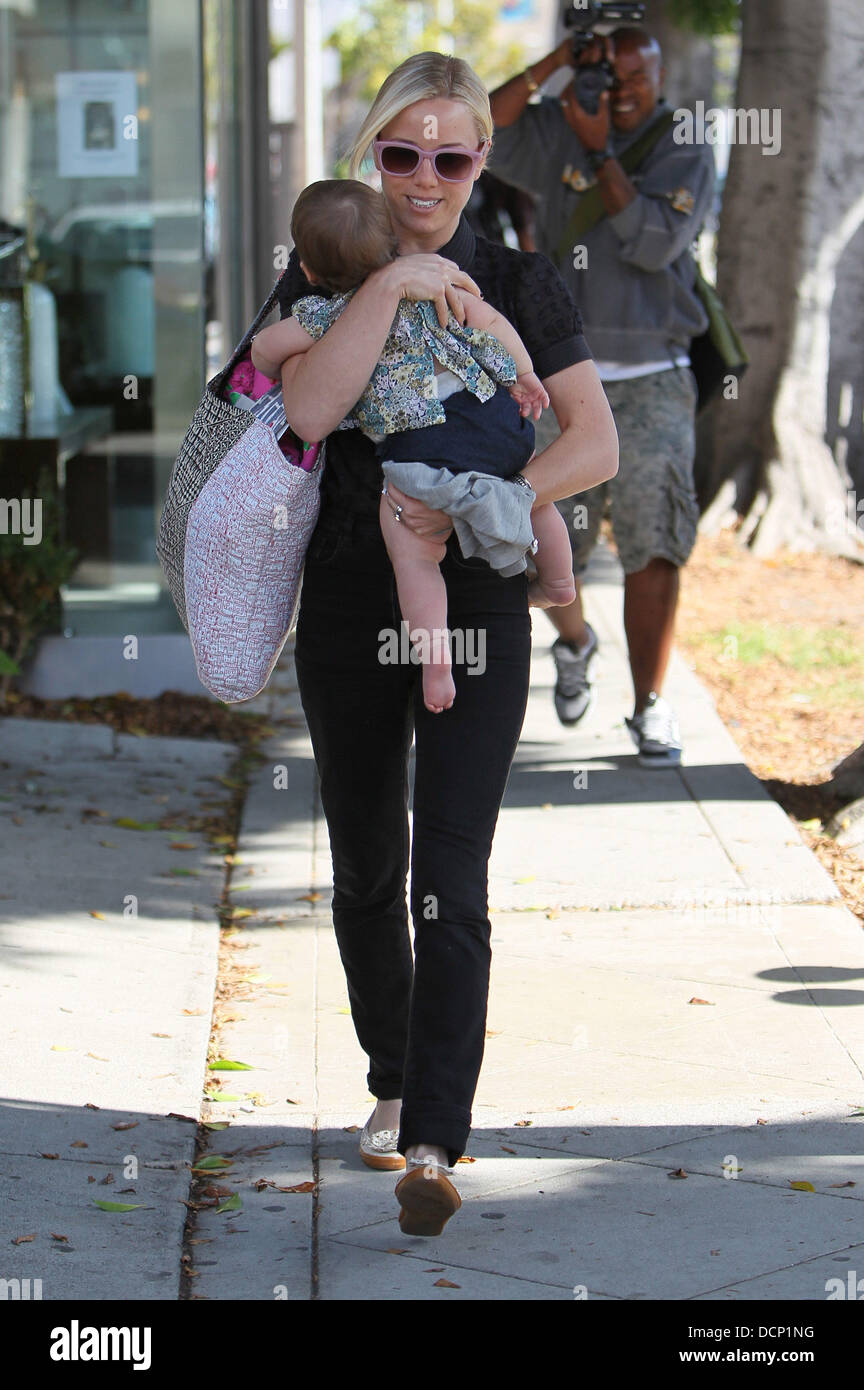 Brady Cunningham carries her daughter Marlowe as she leaves Le Pain ...