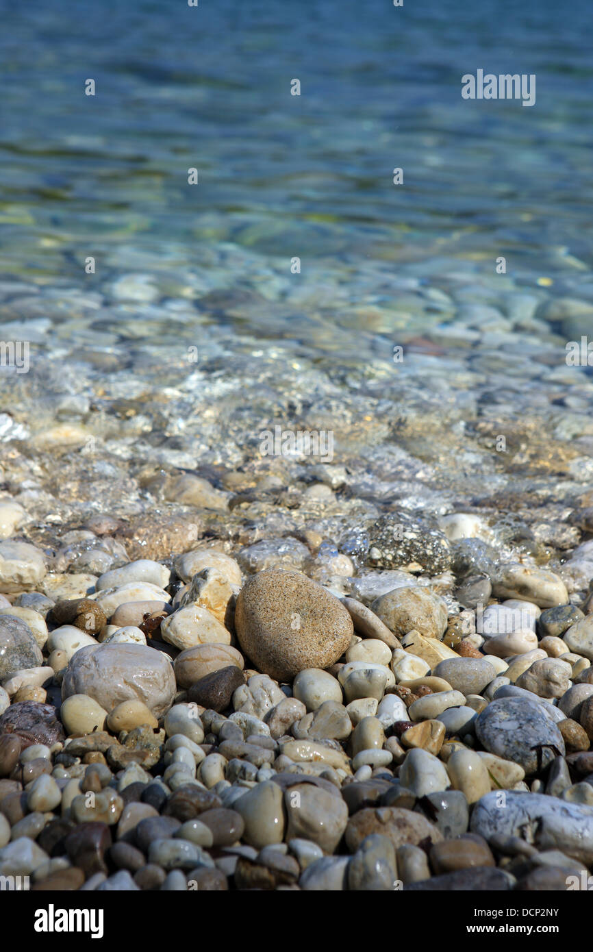 Pebbles at the water's edge on a Greek beach Stock Photo - Alamy