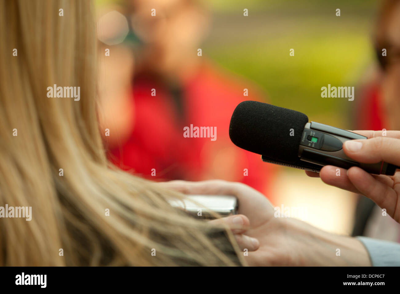 journalist hand holding a microphone conducting an TV or radio interview Stock Photo - Alamy
