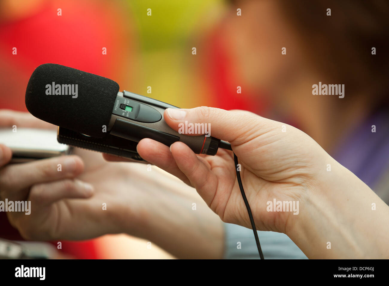 journalist hand holding a microphone conducting an TV or radio interview Stock Photo - Alamy