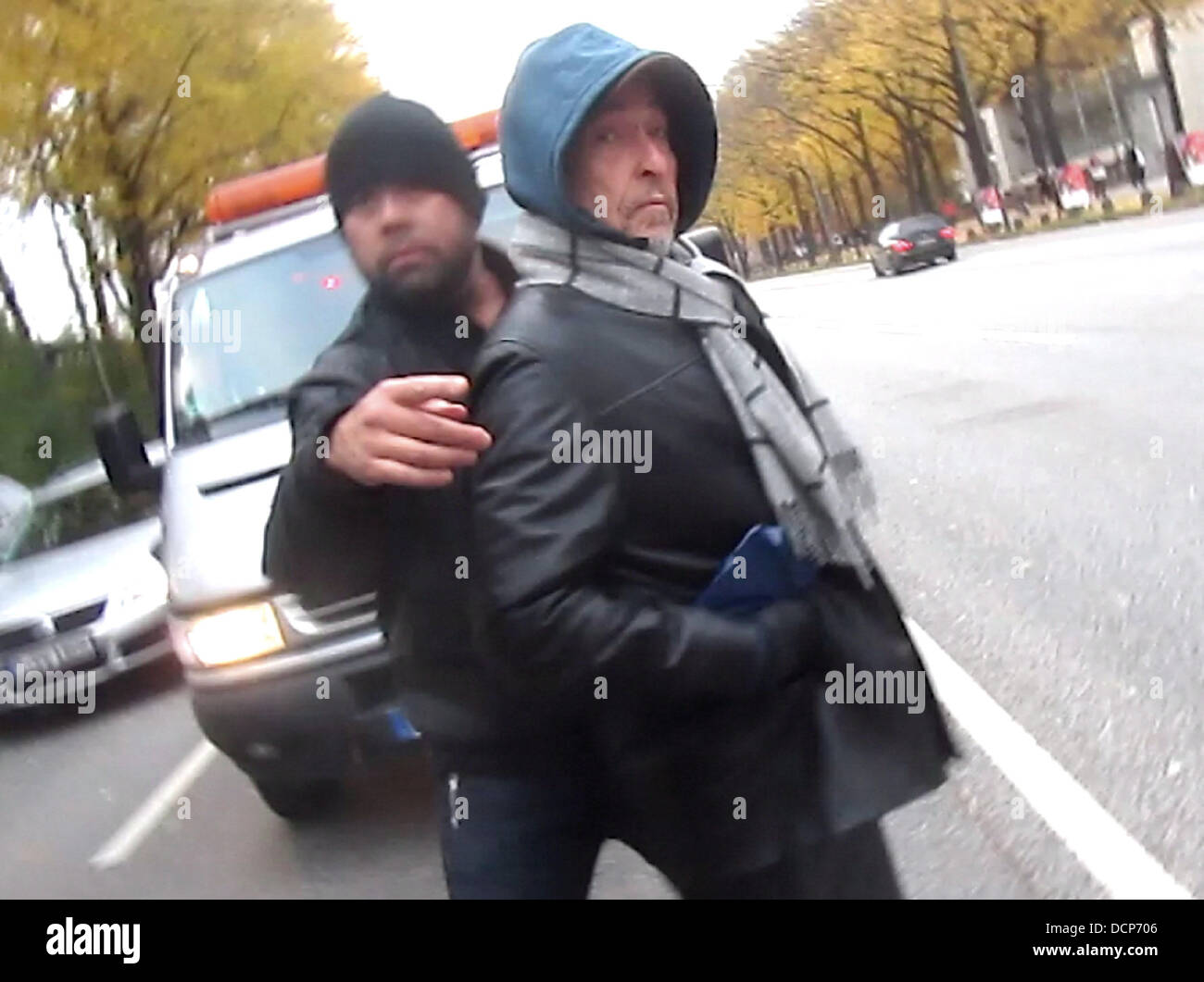 Bob Dylan is ushered by a security guard as he arrives at the O2 arena ...