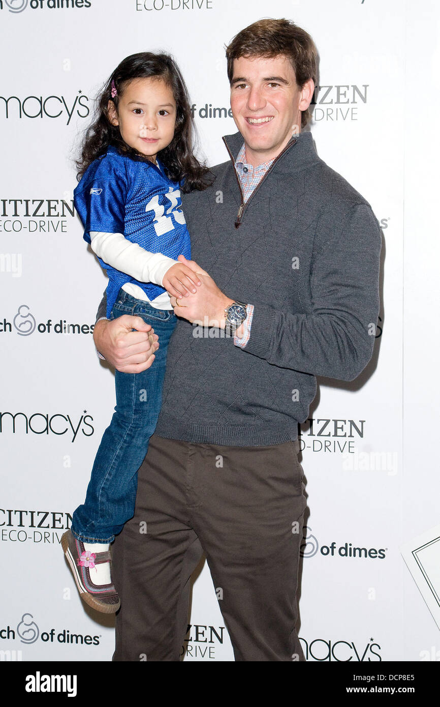 Star Quarterback Eli Manning with and Addison Saji, launches his ...