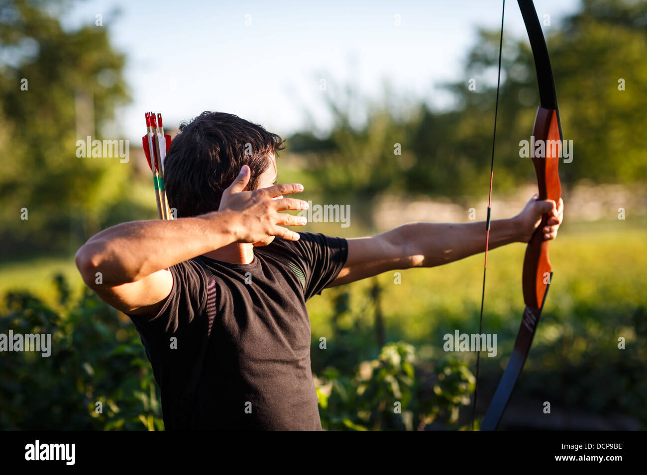 Young archer training with the bow Stock Photo - Alamy