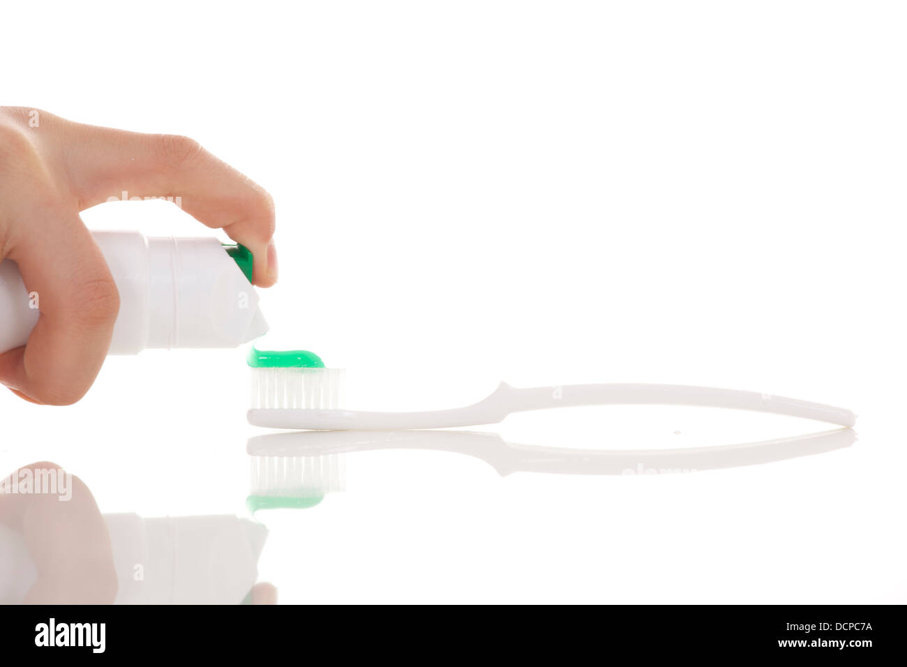 Squeezing toothpaste onto toothbrush Stock Photo - Alamy