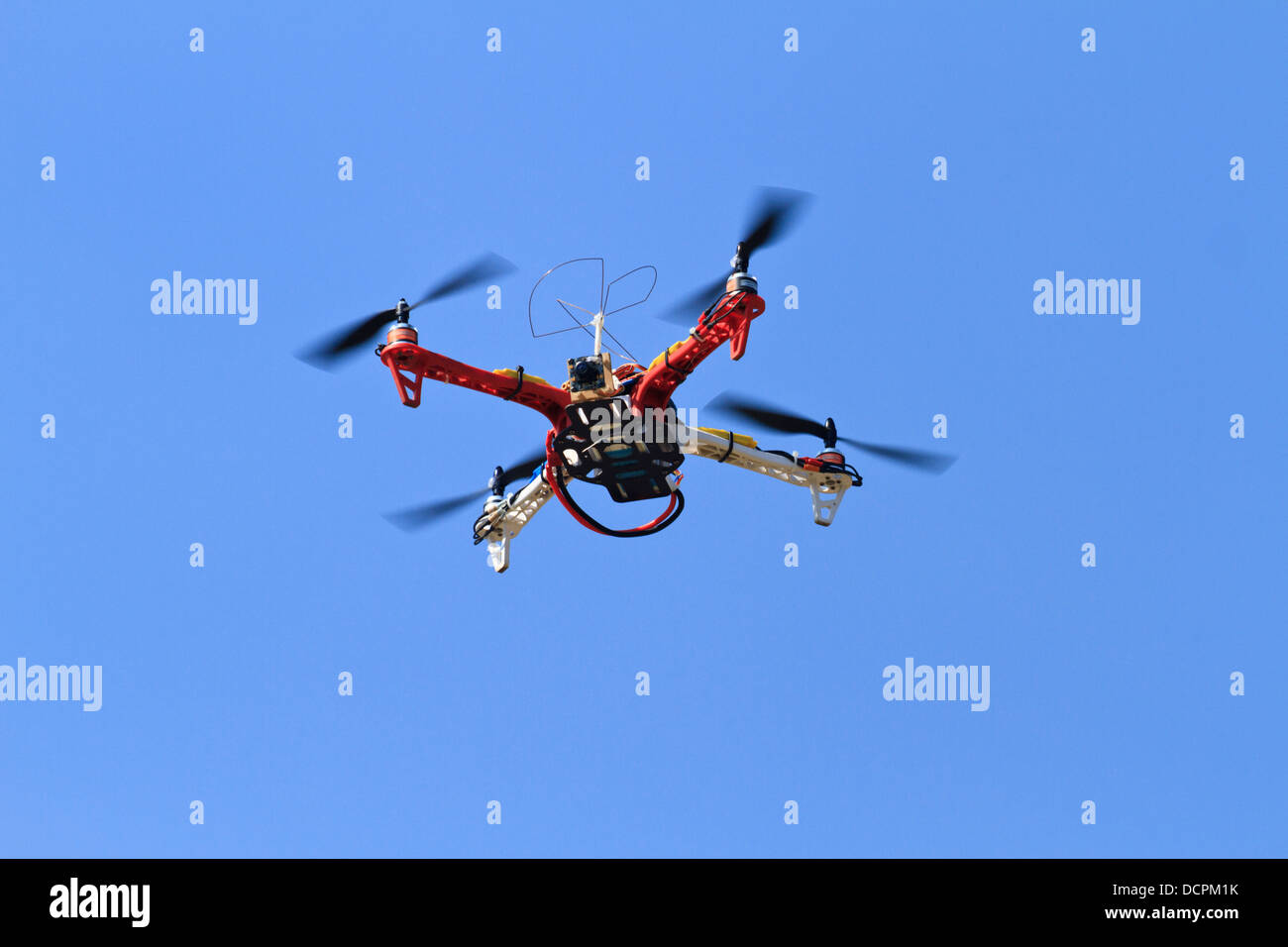 Unmanned Aerial Vehicle (UAV) - Quadcopter with small camera at the air ...