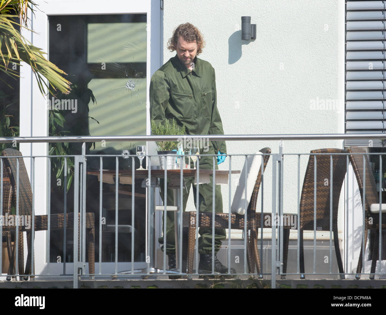 Heidelberg, Germany. 21st Aug, 2013. A police officer secures evidence ...