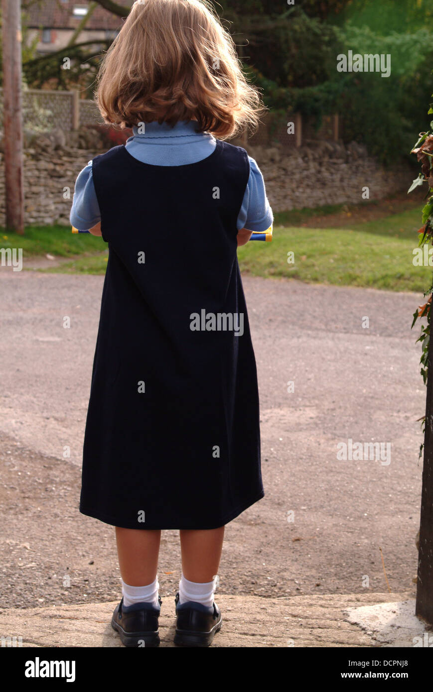 Young girl wearing school uniform, back view Stock Photo - Alamy