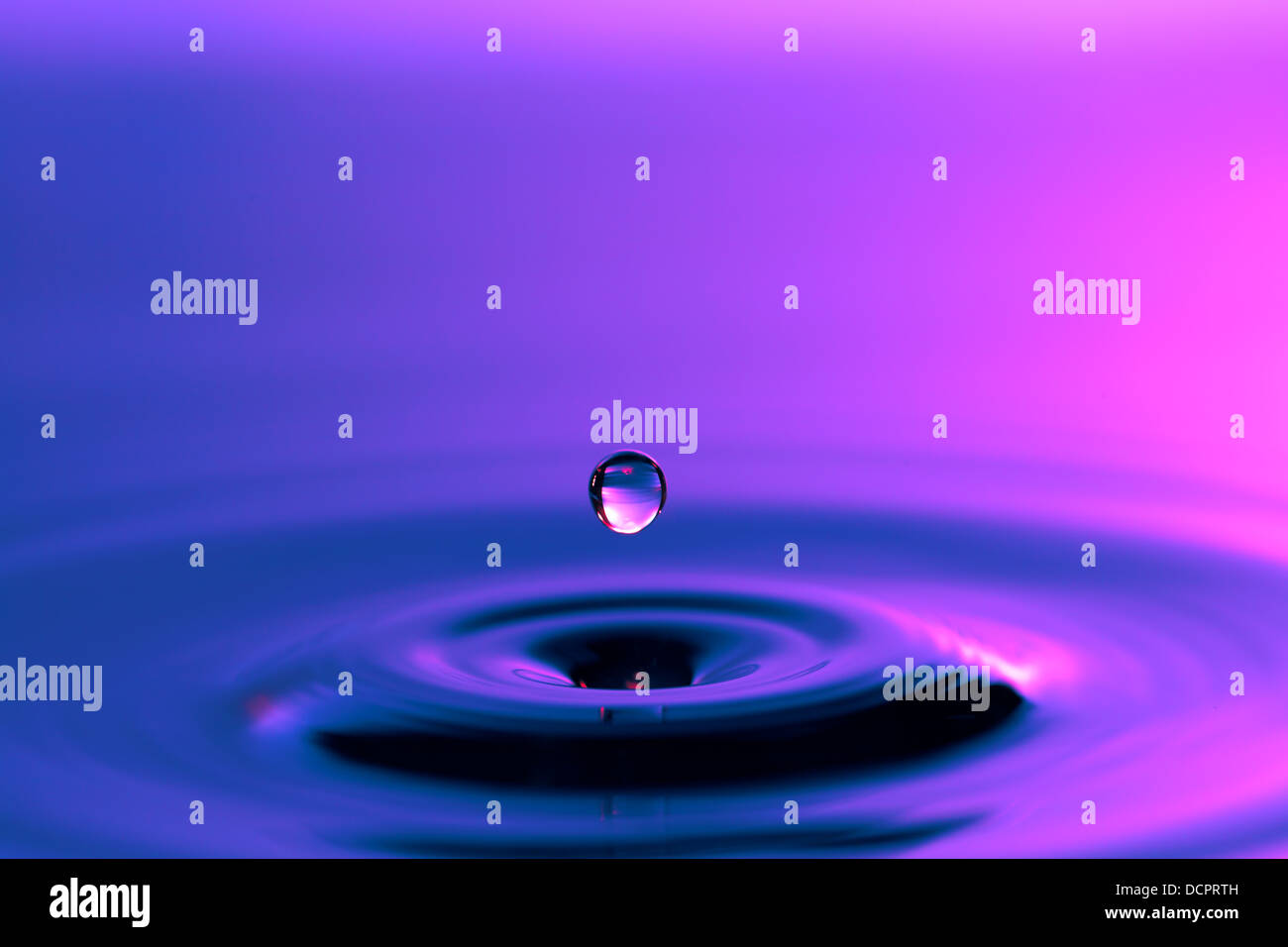 Water drop falling to a liquid surface Stock Photo - Alamy