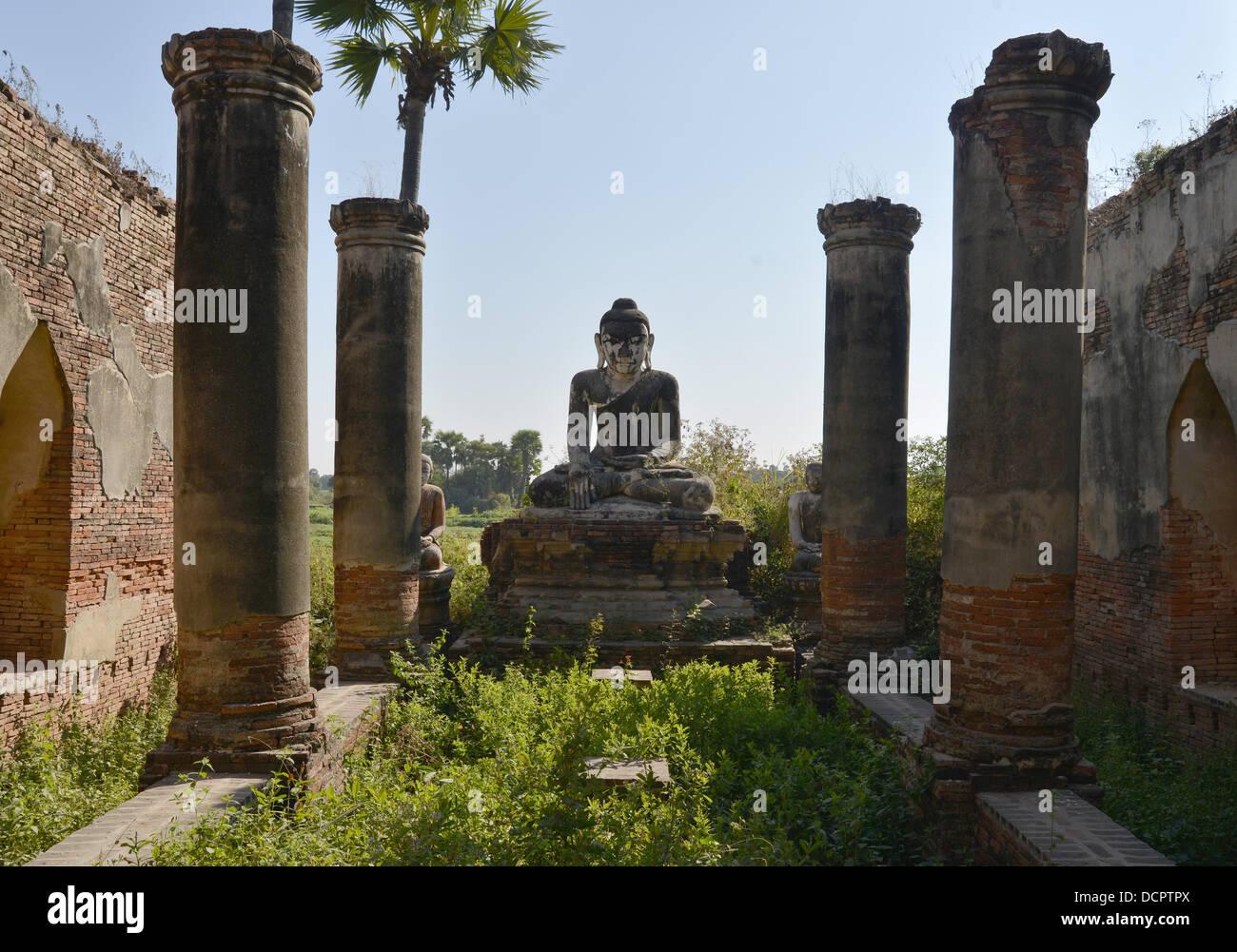 A Buddha statue in the remains of a pagoda in ancient burmese capital ...