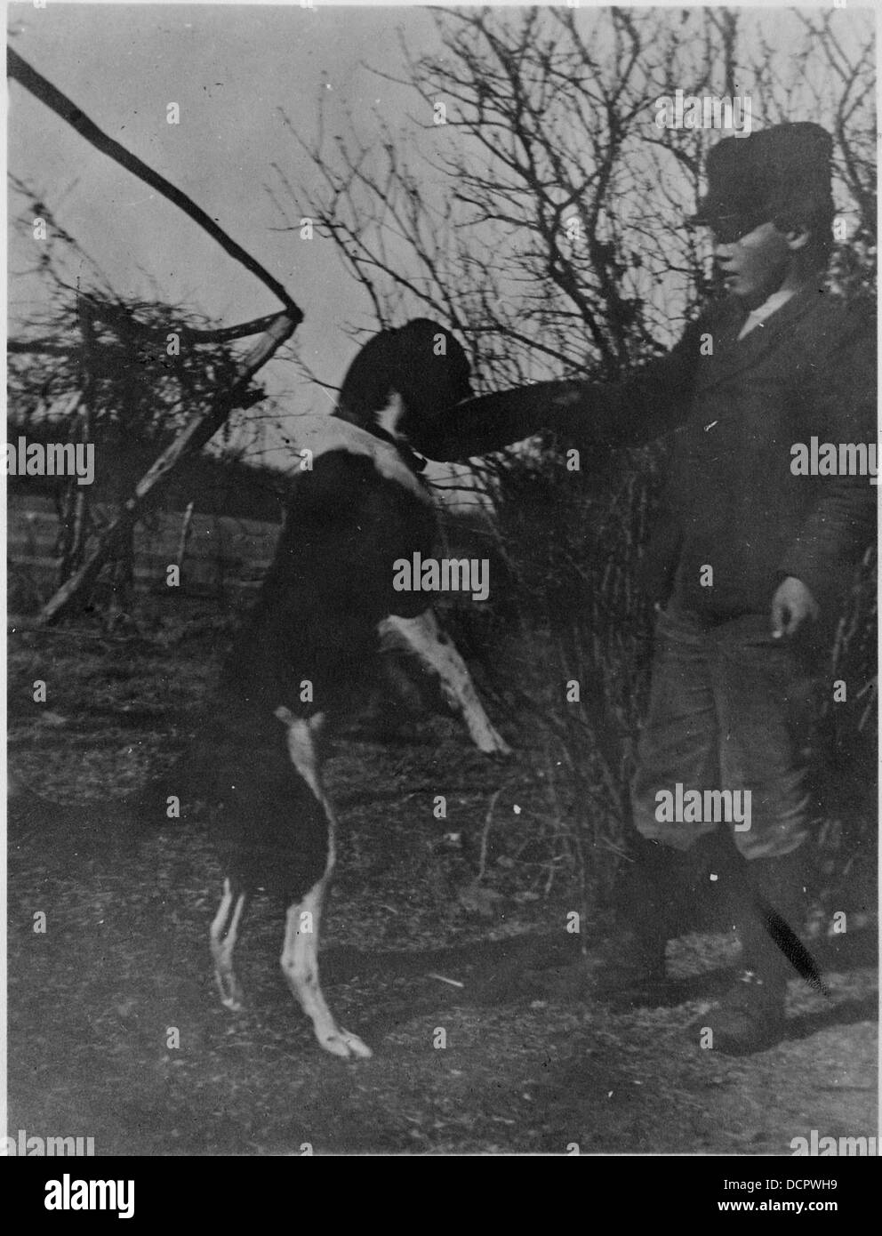 This image depicts a boy and a dog at the Wind River Reservation ...