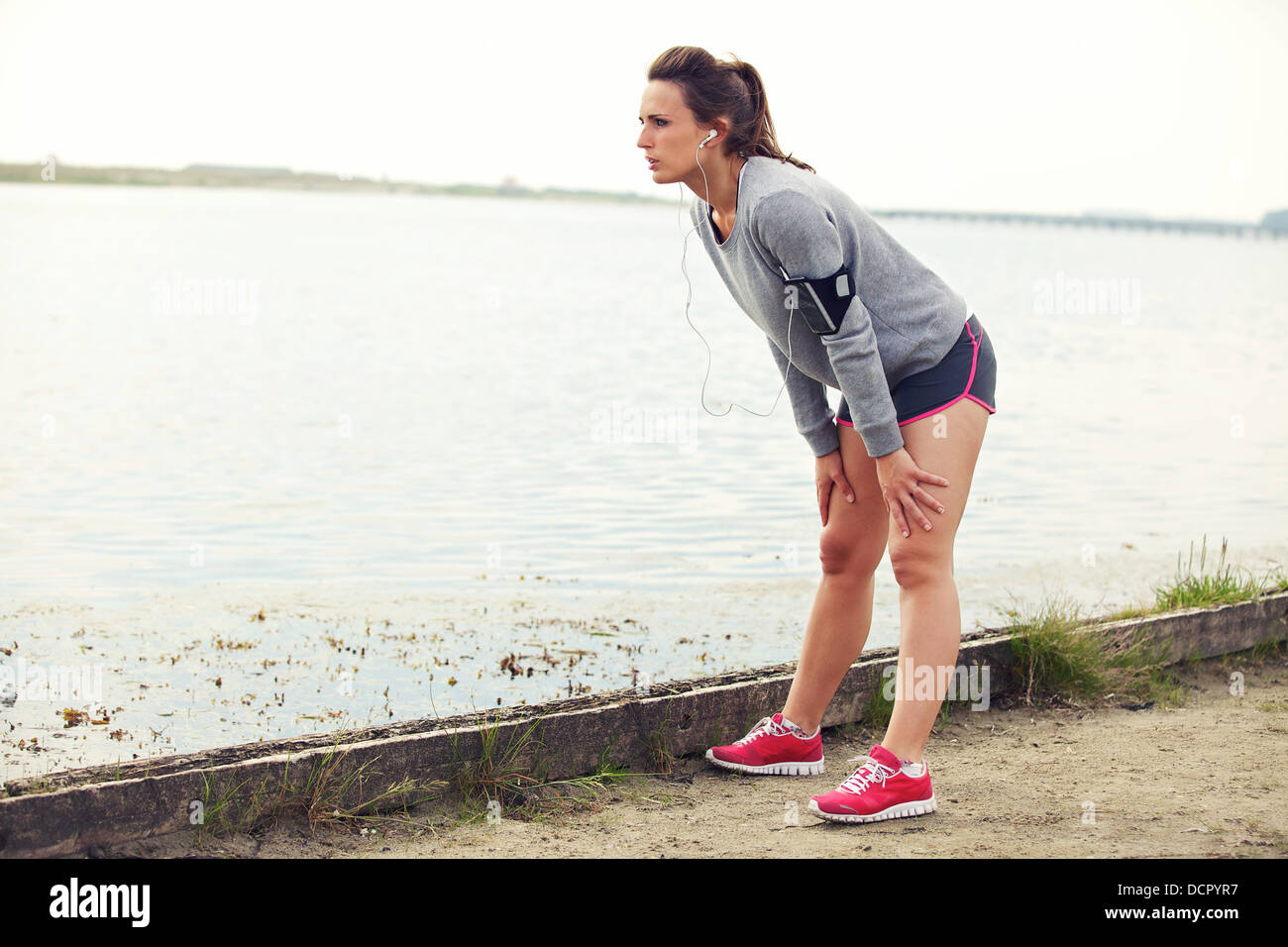Female taking a break after running Stock Photo - Alamy