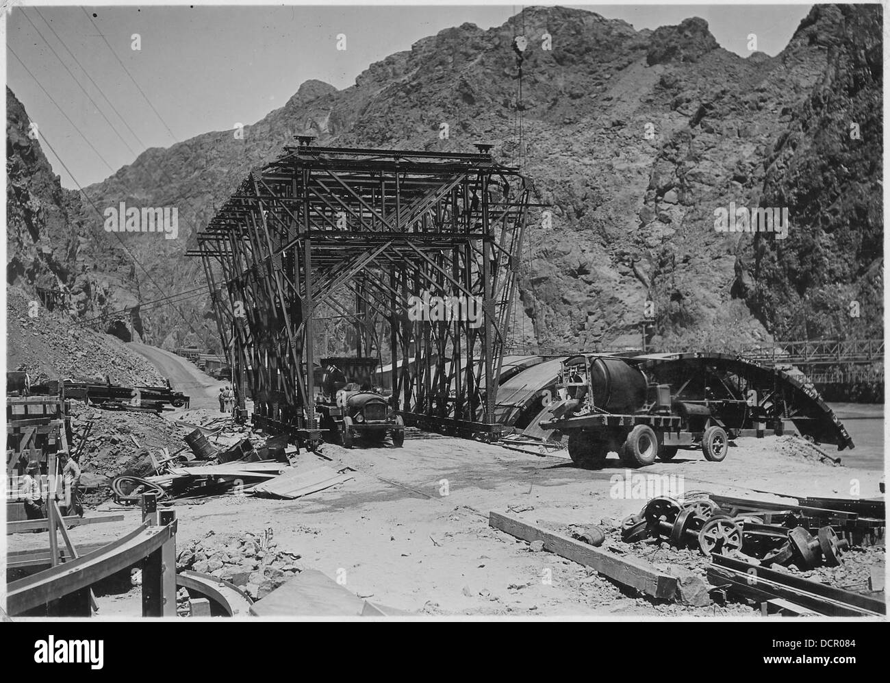 The image depicts workers fabricating steel-frame carriages used for ...