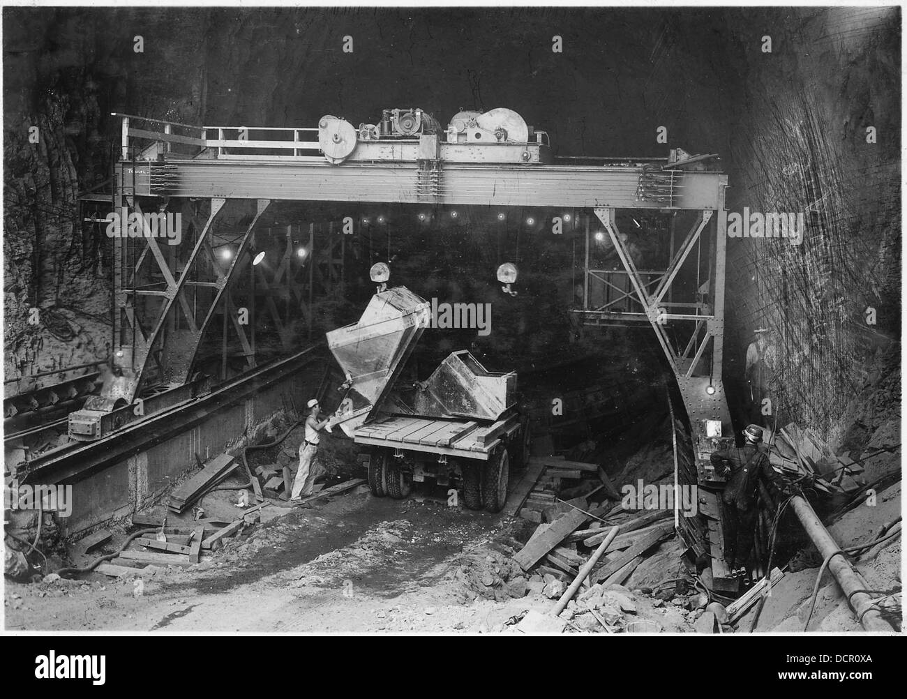 A Gentry crane unloads bottom dump concrete buckets from a truck inside ...