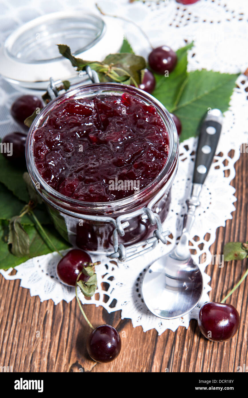 Glass with homemade Cherry Jam on wooden background Stock Photo - Alamy