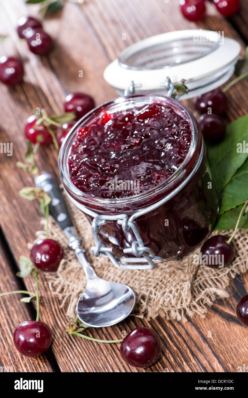 Fresh made Cherry Jelly with fruits on wooden background Stock Photo ...