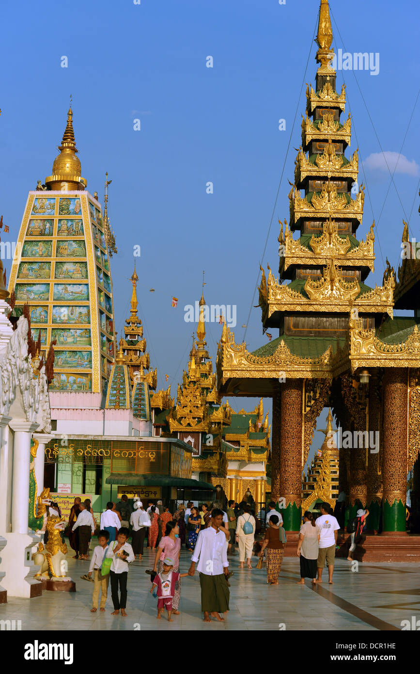 Believers walk on the compound of the Shwedagon pagoda between ...