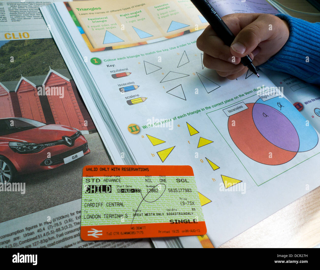 A Great Western train ticket and boy doing maths homework in train ...
