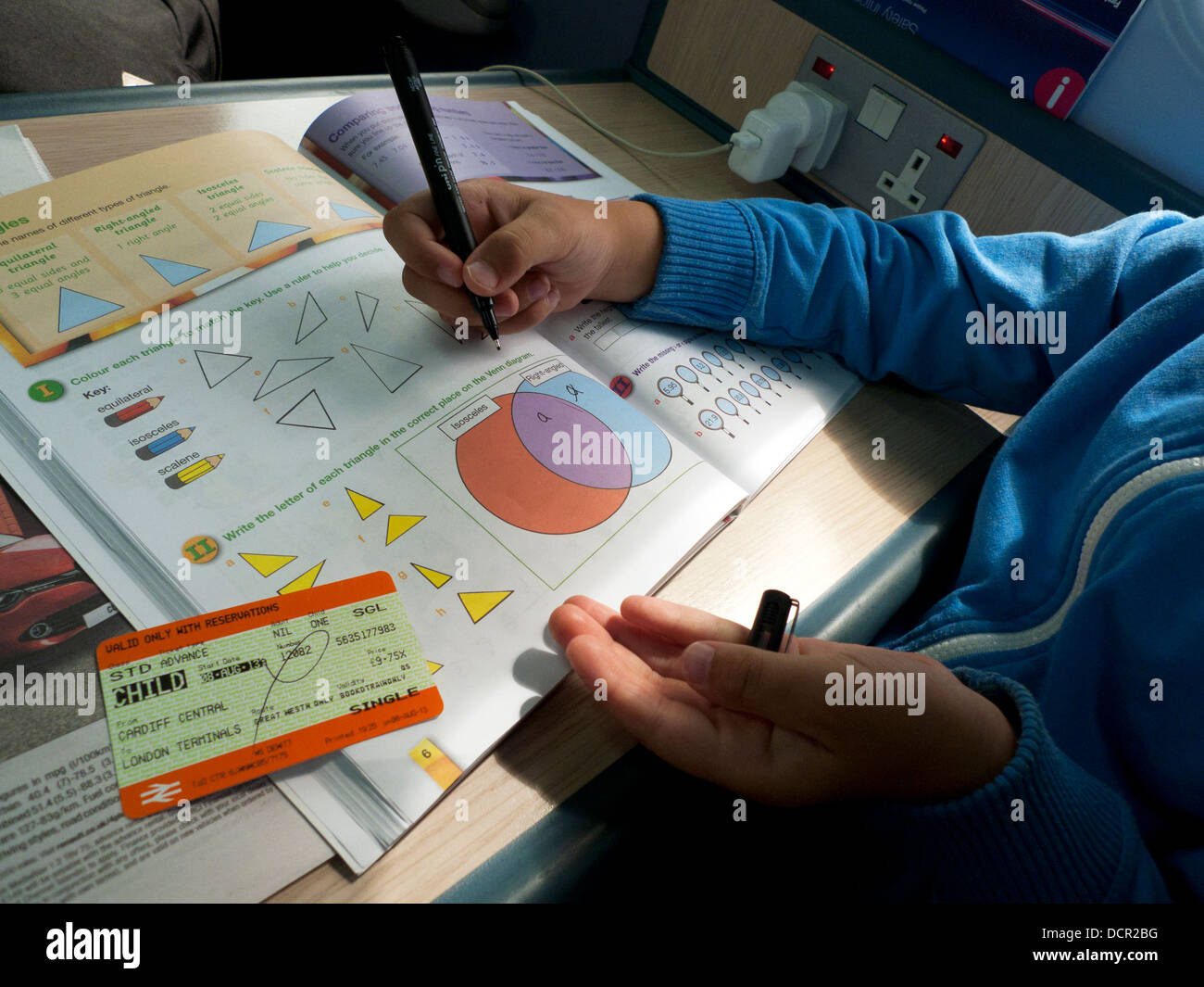 Great Western child's train ticket boy doing maths homework in train ...