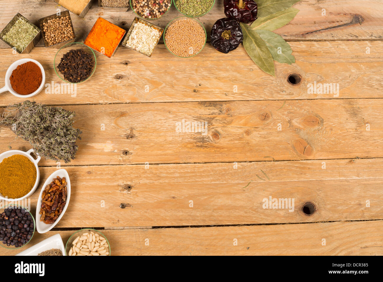 Assorted spices on an old wood background Stock Photo - Alamy