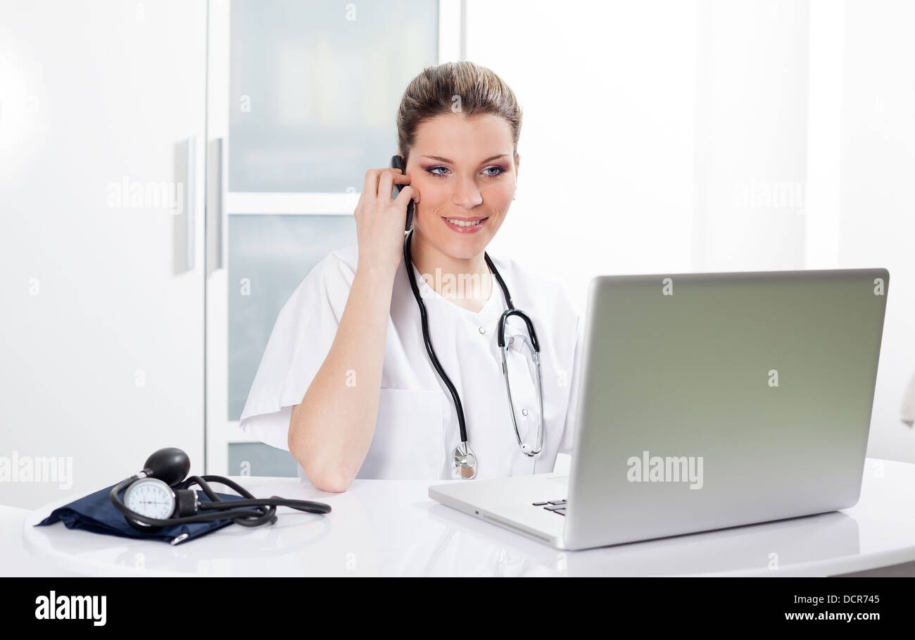 doctor in hospital with computer and phone Stock Photo - Alamy