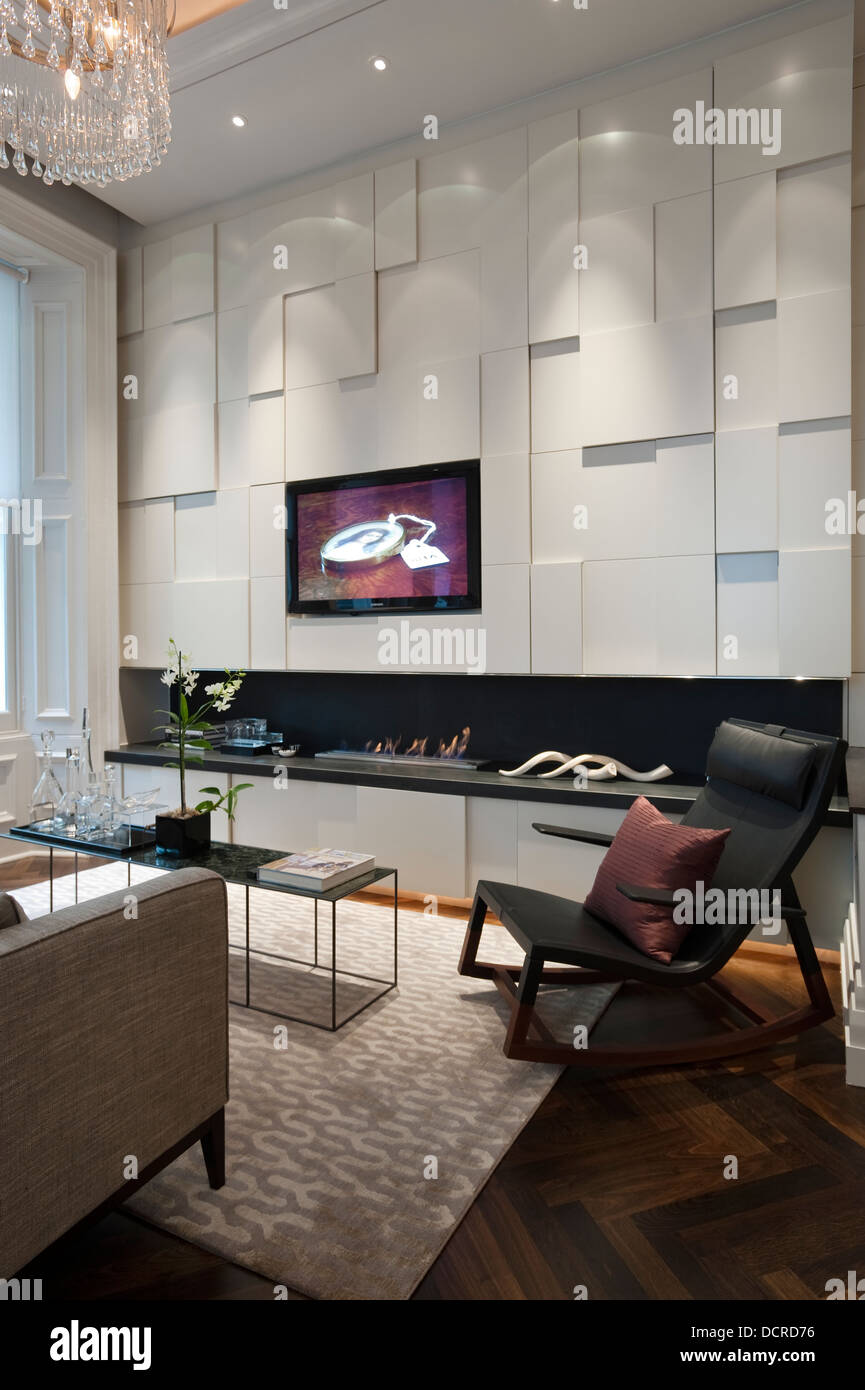 Rocking chair with plasma screen in London city apartment Stock Photo ...