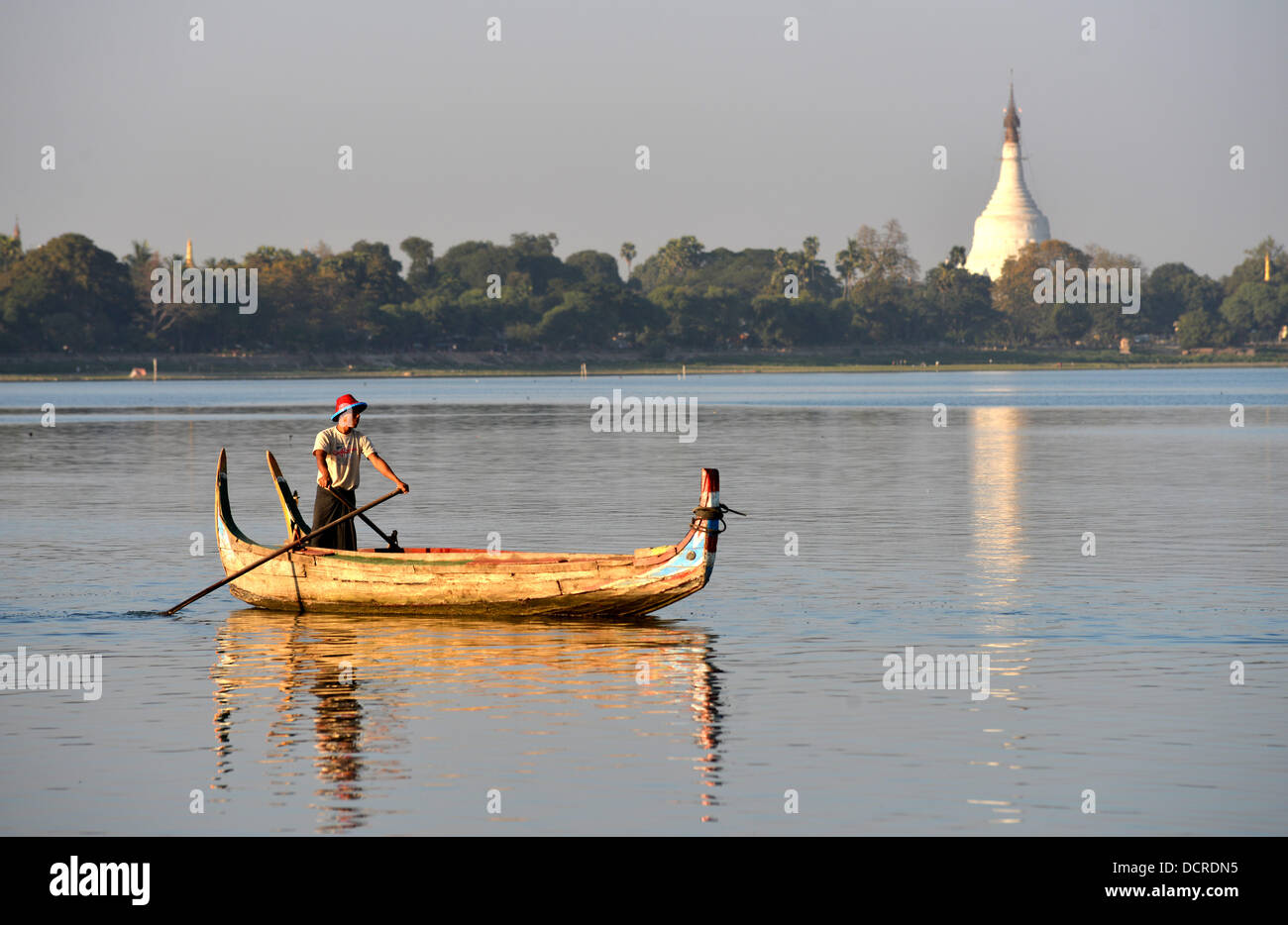 An oarsman with his boat on a lake near Amarapura, a stupa in the ...