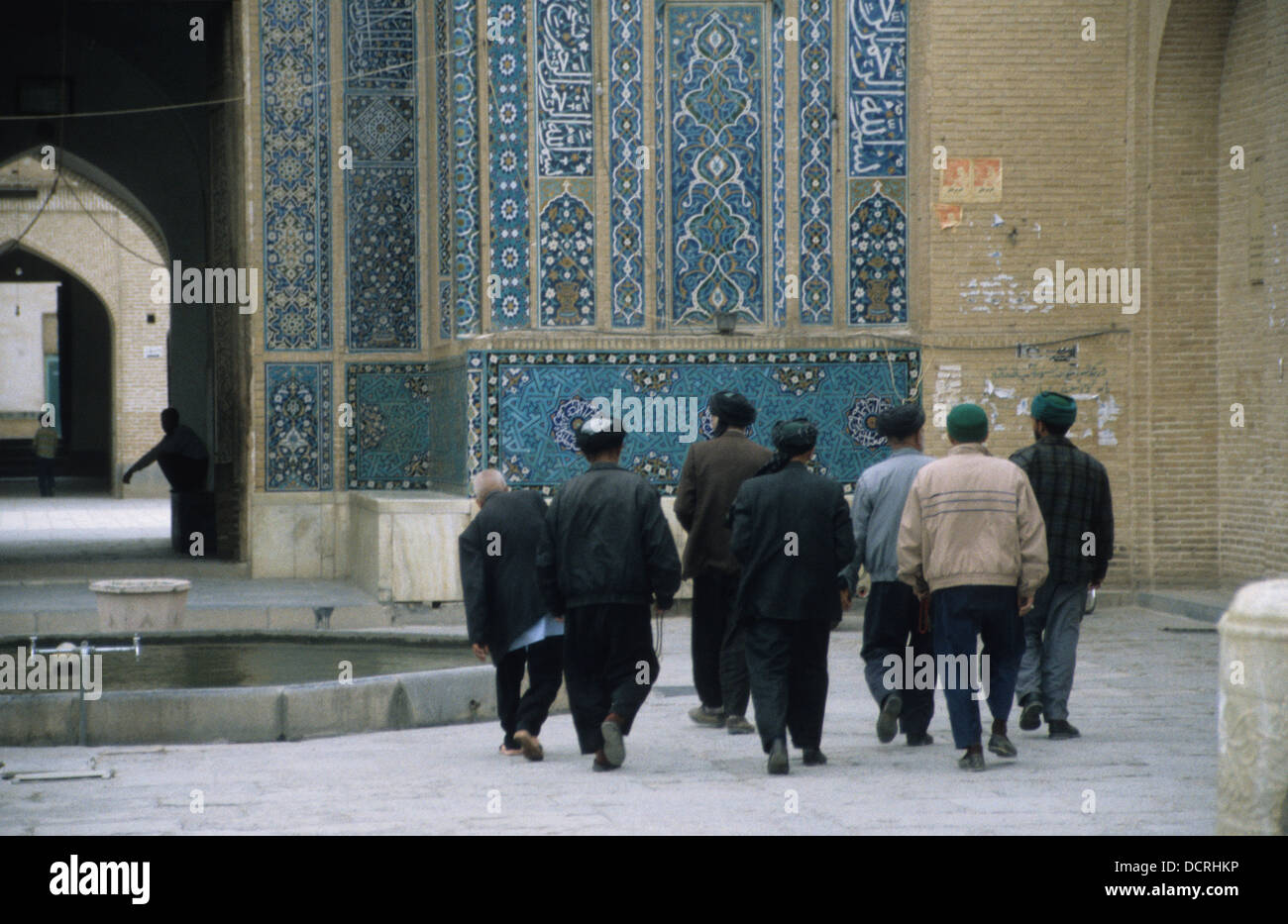 Group of Iranian men and clerics make their way to Friday Prayers at ...