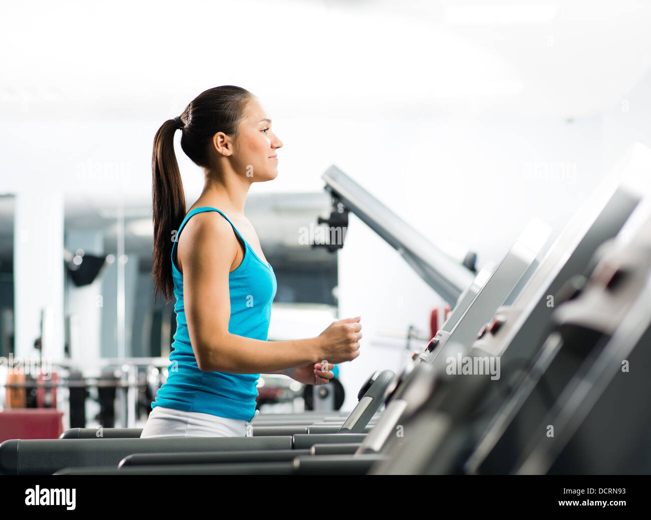 attractive young woman runs on a treadmill Stock Photo - Alamy