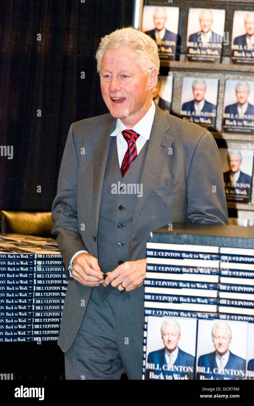 Former U.S. President Bill Clinton signs copies of "Back to Work: Why ...