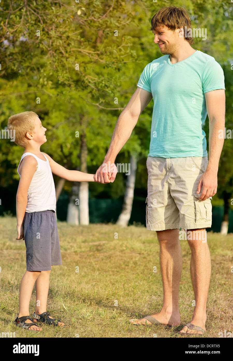Family Father Man and Son Boy Child holding hand in hand Outdoor ...
