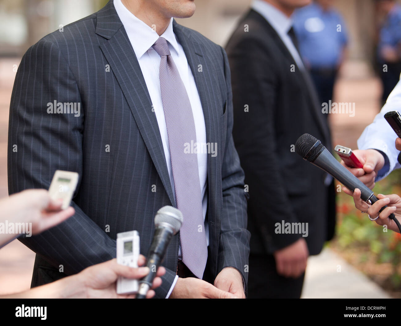 interview with media microphone held in front of business man ...