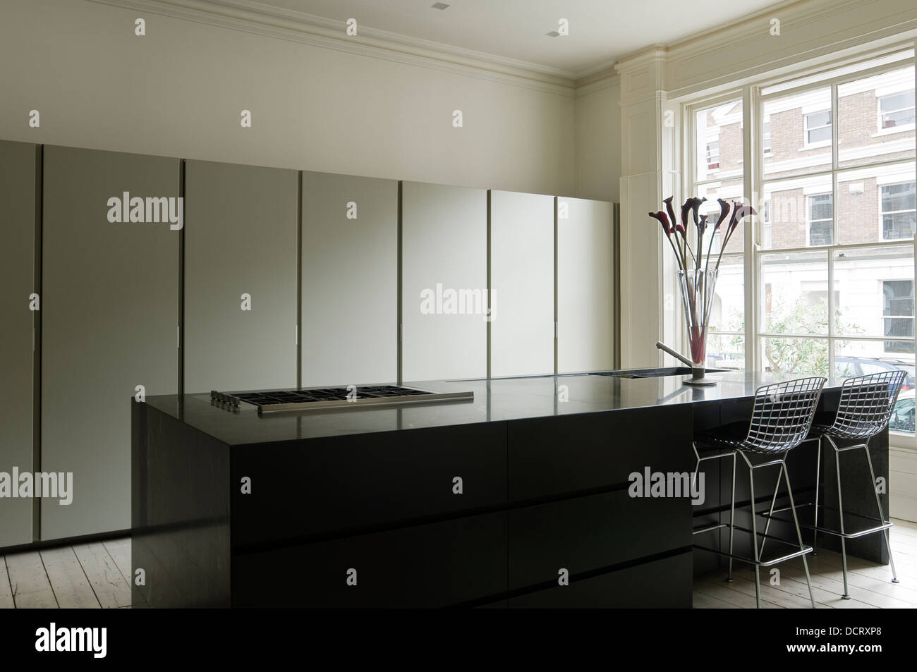 Minotti kitchen with streamlined cupboards and granite island with ...